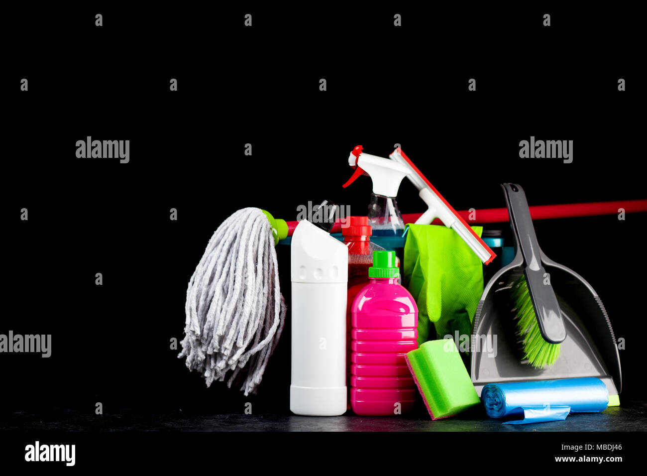 Cleaning supplies on black background Stock Photo - Alamy