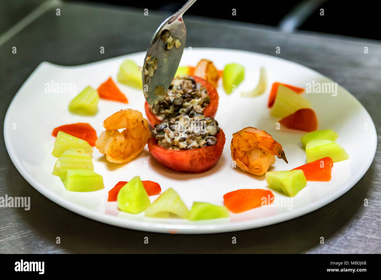 Making salad on white plate at cooking workshop Stock Photo - Alamy