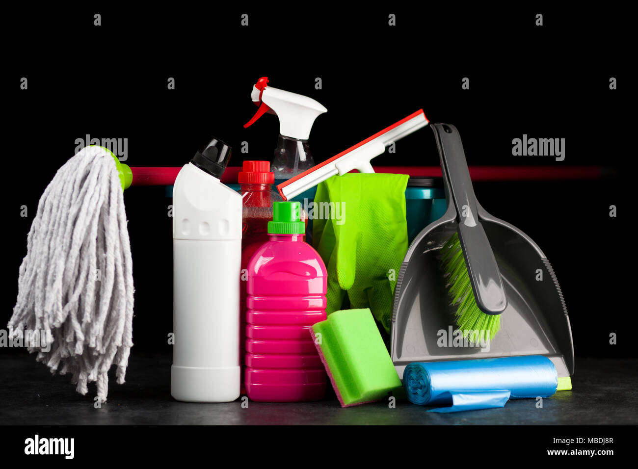 Cleaning supplies on black background Stock Photo - Alamy