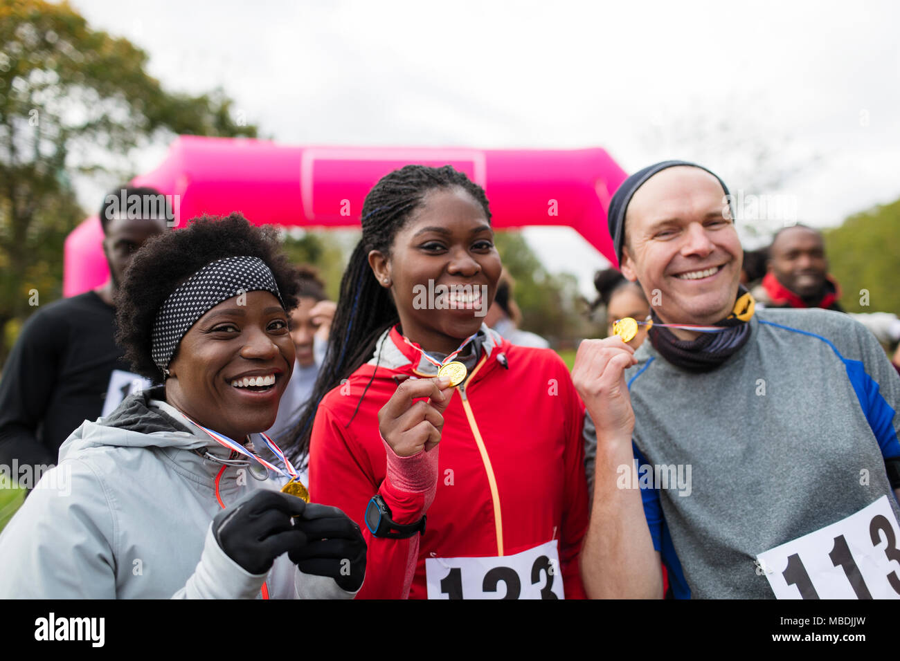 Portrait smiling runners with medals at charity run Stock Photo - Alamy