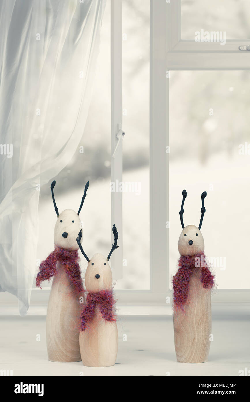 Winter window with little wooden reindeer Stock Photo - Alamy