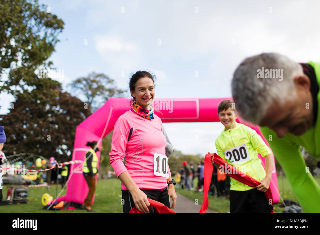 Family runners crossing finish line at charity run Stock Photo - Alamy