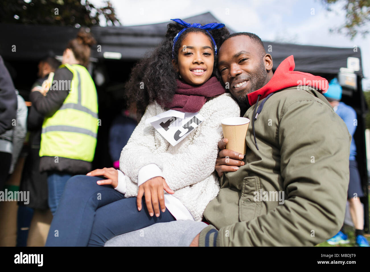 Portrait smiling father and daughter runners before charity run Stock ...