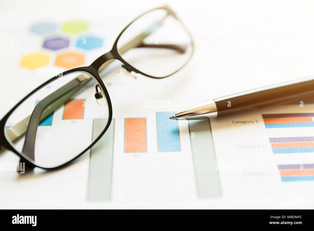 Preparing report. Graphs and charts. Business reports, glasses and pen ...