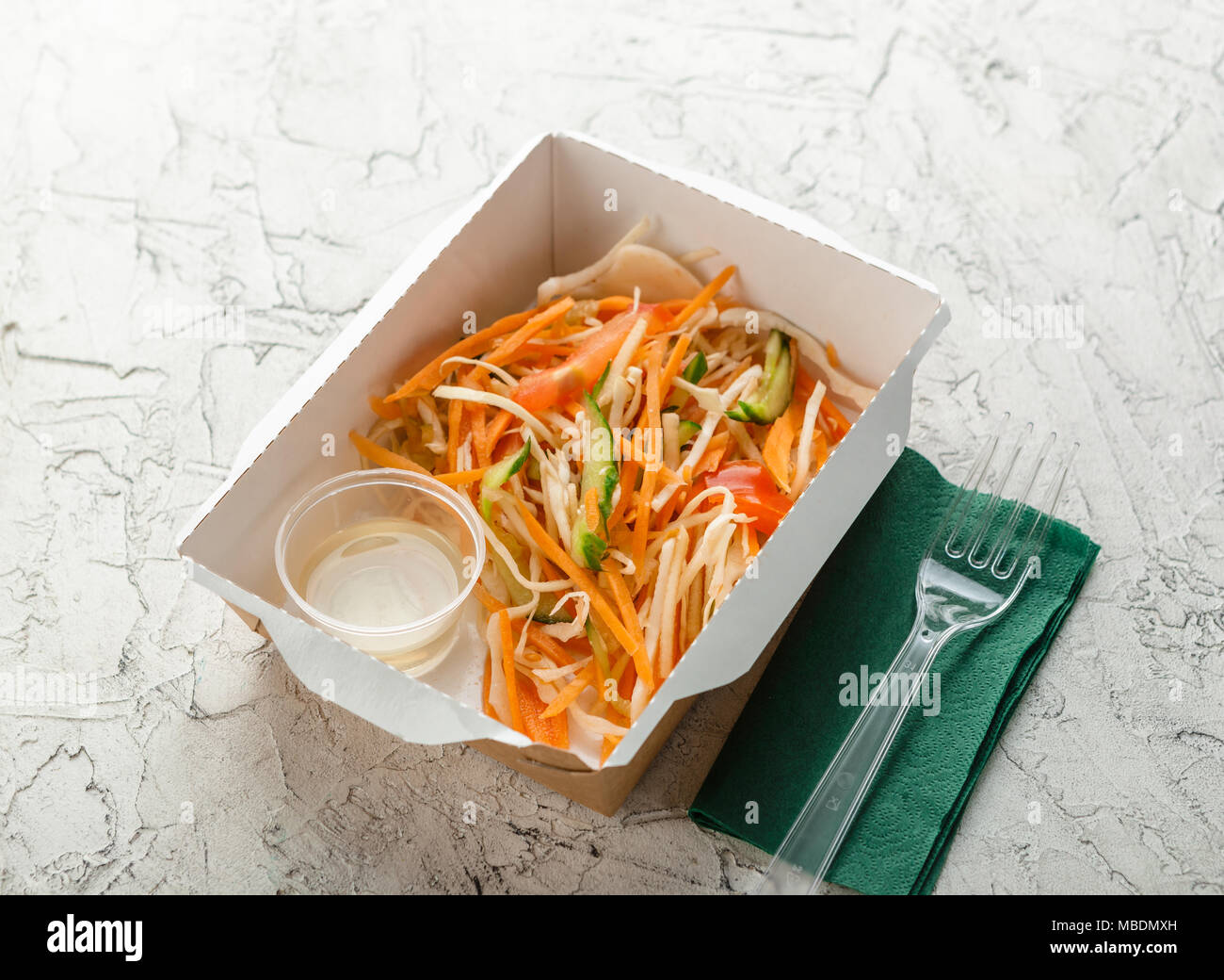 Healthy food delivery. Cabbage salad with carrots, tomatoes and ...