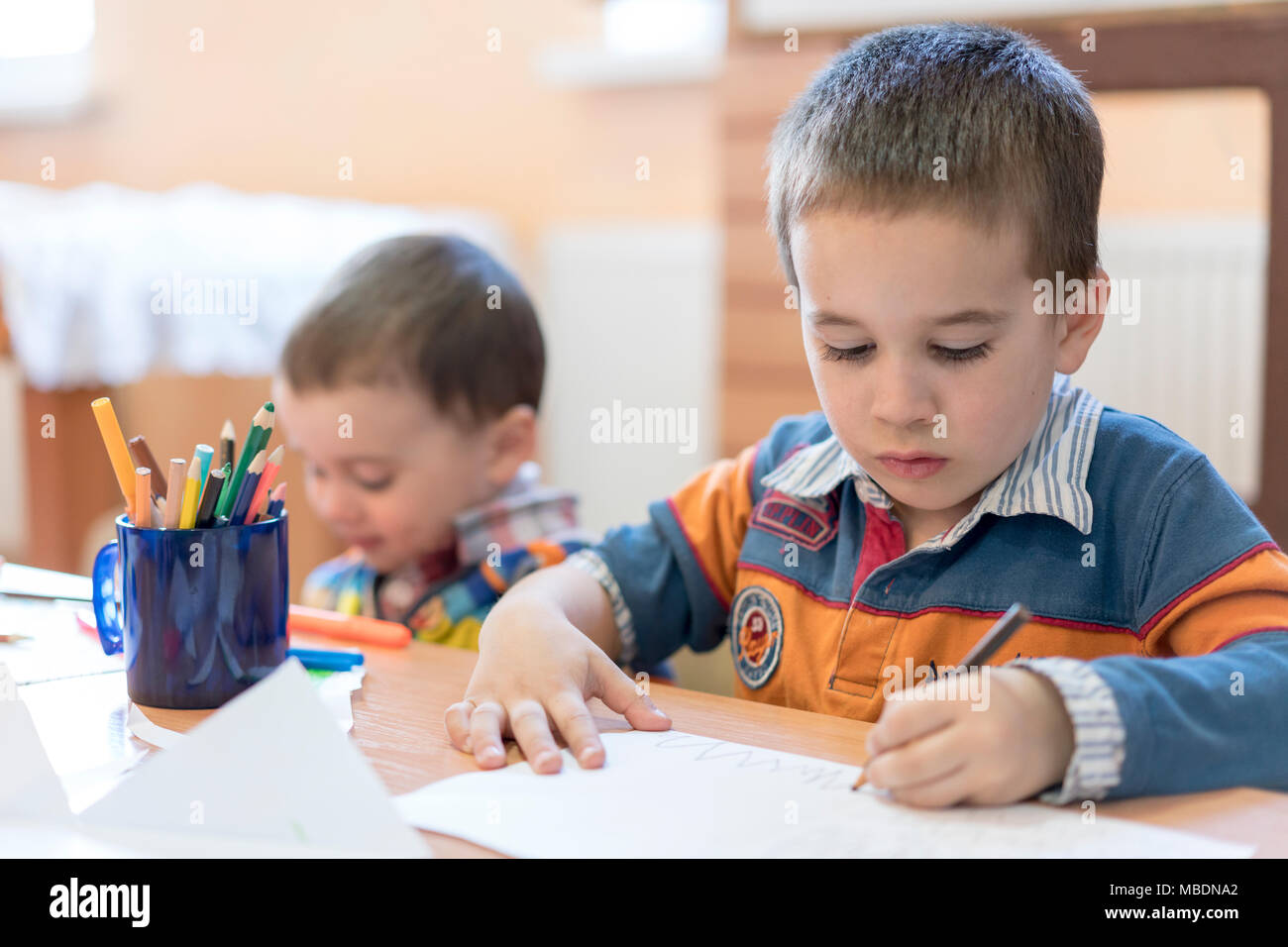 Two kids drawing at kindergarten Stock Photo - Alamy