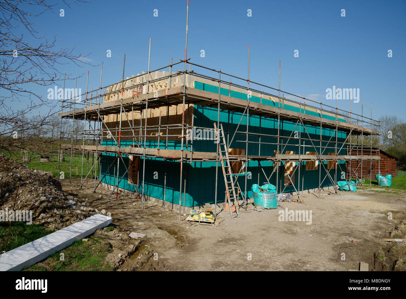 Scaffolding framework around a modern timber framed building Stock ...