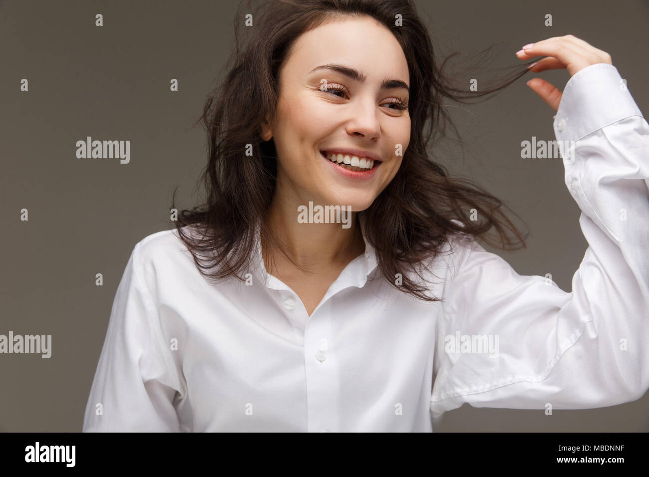 Beautiful girl in a white shirt shows emotions - smile, fun Stock Photo ...