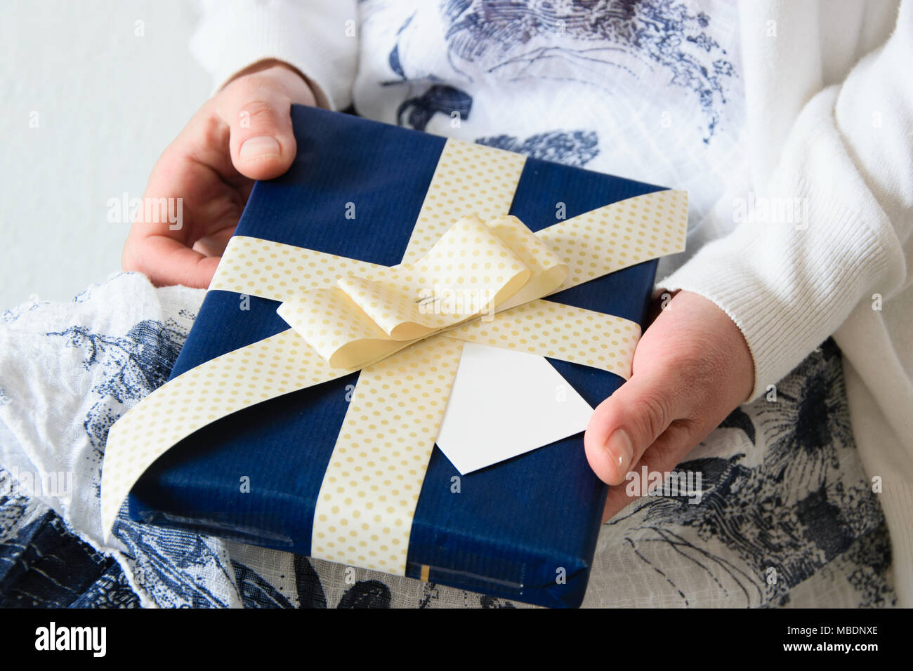Front view of woman hands giving a gift box Stock Photo - Alamy
