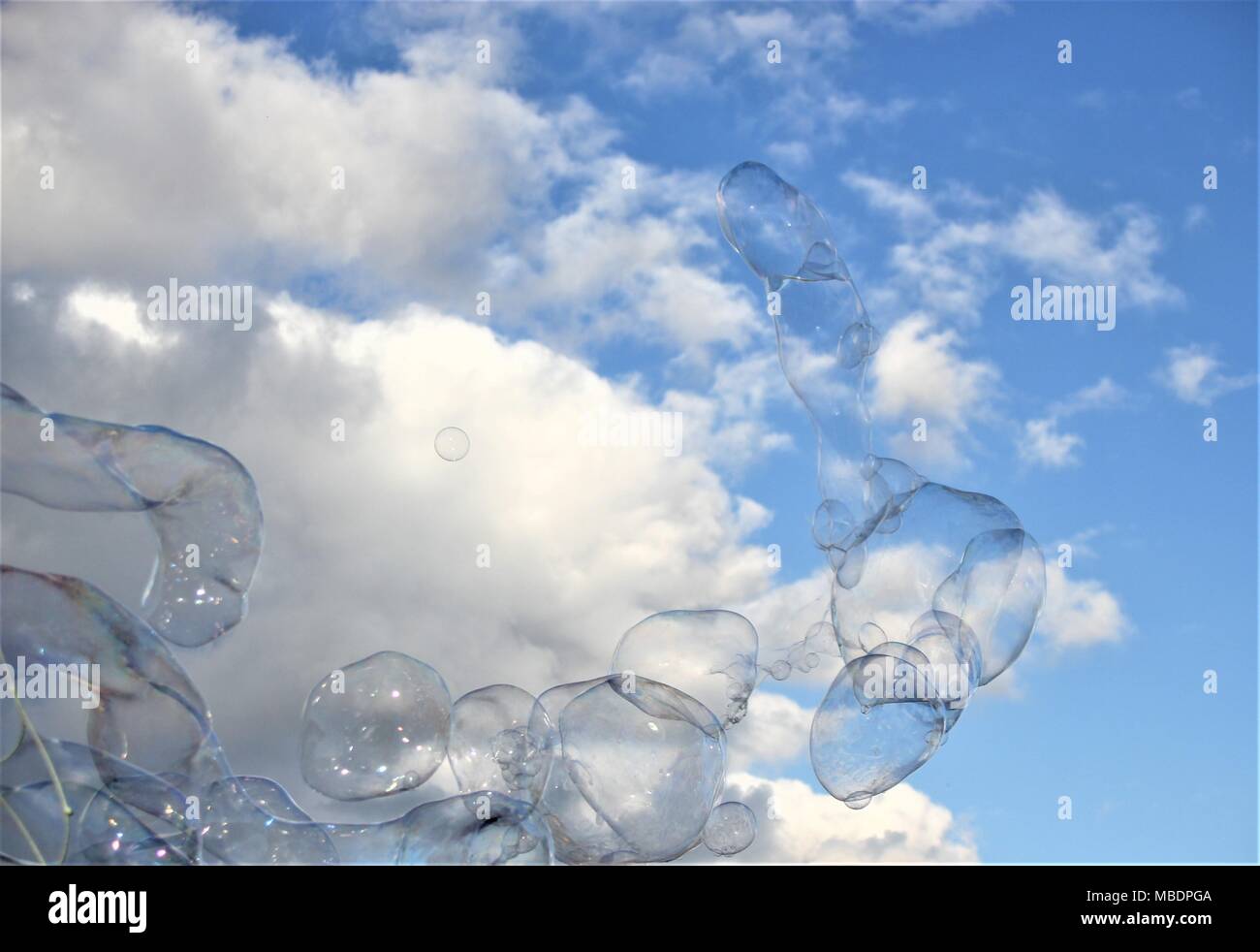bubble background bubbles soap soapy float blue cloud cloudy sky simple modern Stock Photo - Alamy