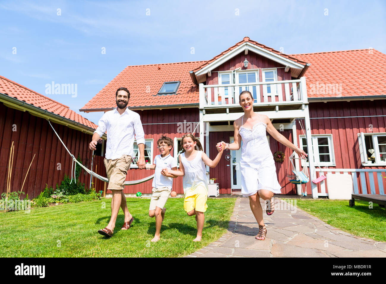 Happy family running on sunny hi-res stock photography and images - Alamy