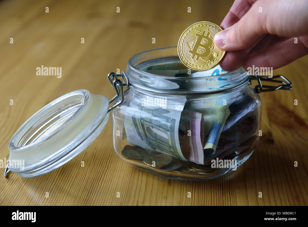 Money jar hand hi-res stock photography and images - Alamy