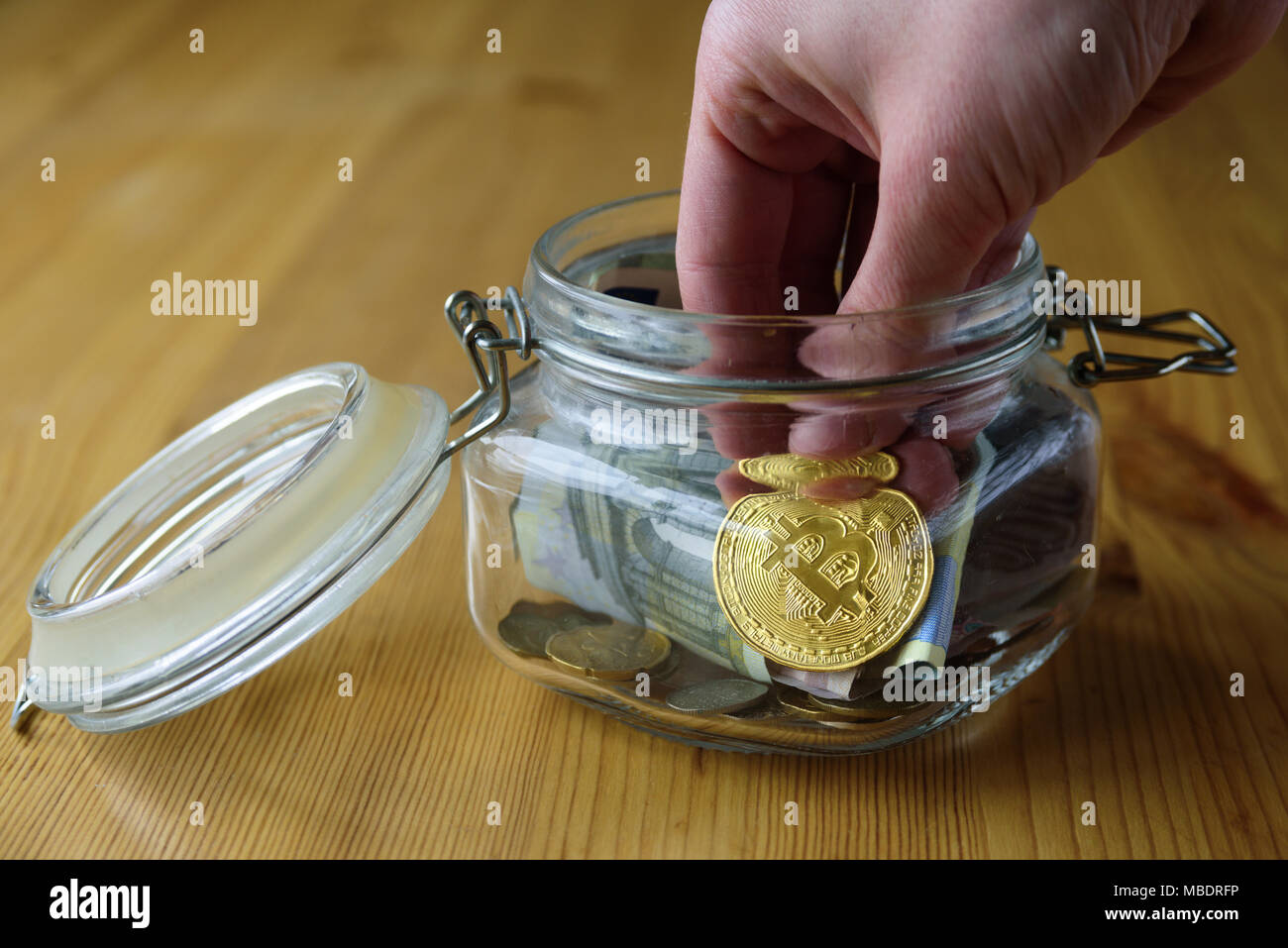 Money jar hand hi-res stock photography and images - Alamy