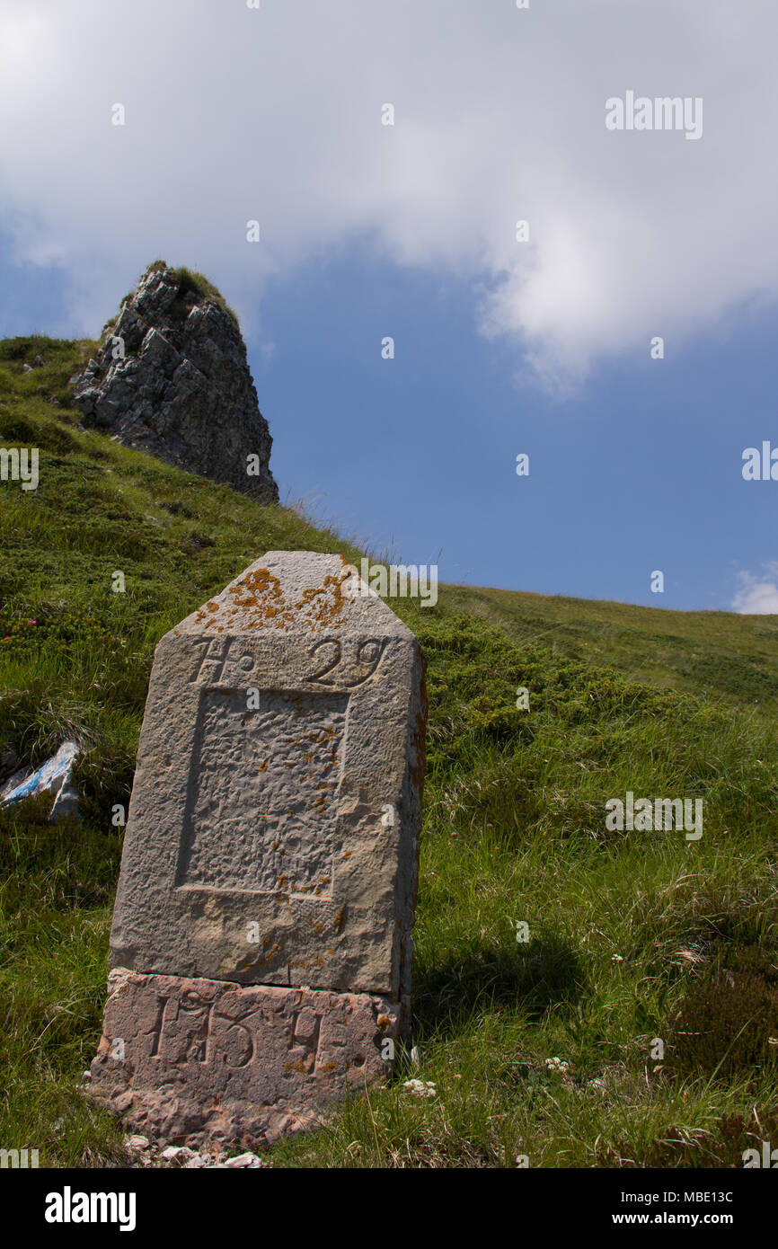 A gravestone overlooking a steep drop on top of Monte Baldo, Italy ...