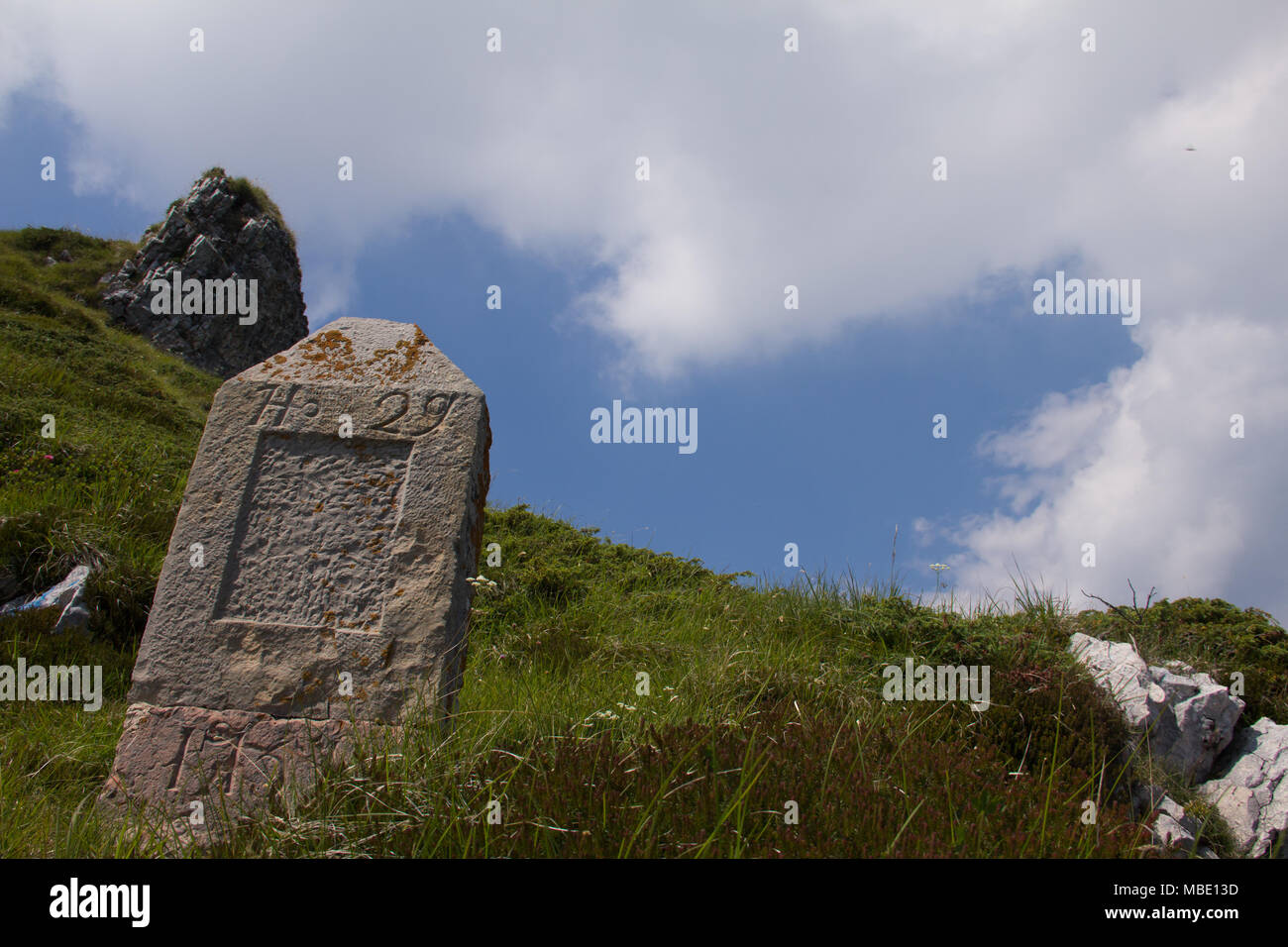 A gravestone overlooking a steep drop on top of Monte Baldo, Italy ...