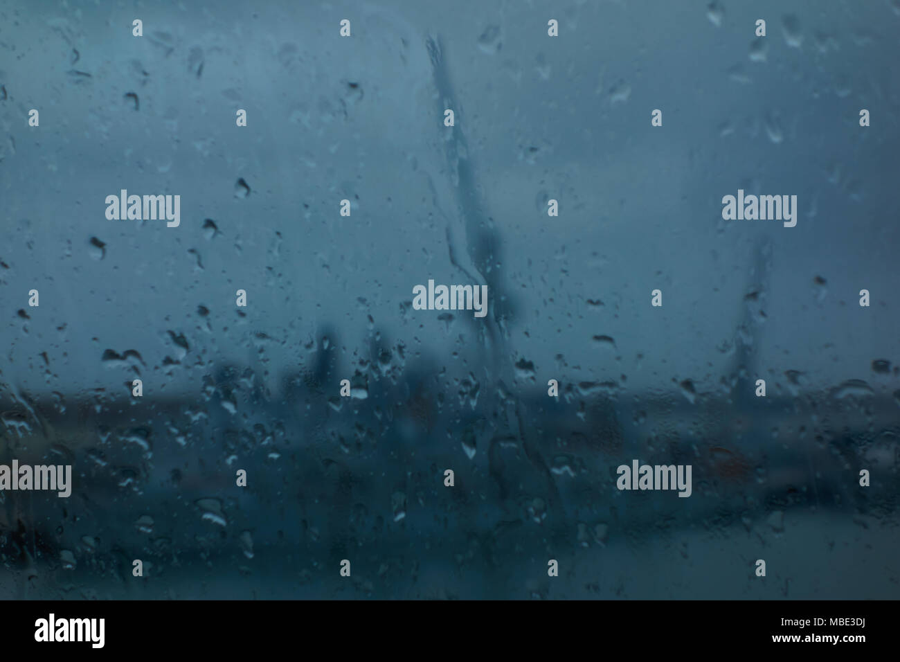 Rain on a window overlooking a harbour Stock Photo - Alamy