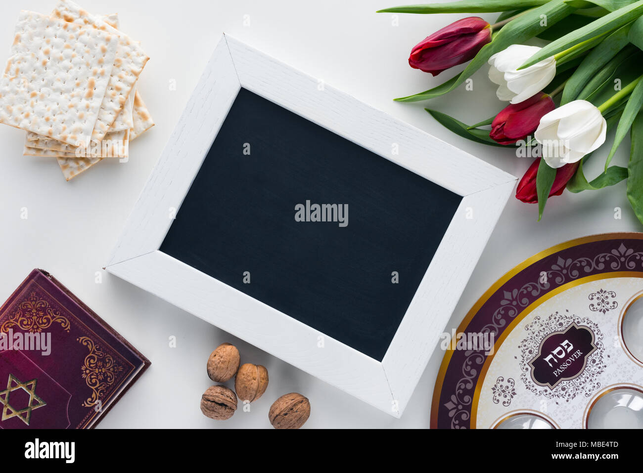 top view of traditional book with text in hebrew and blackboard on ...