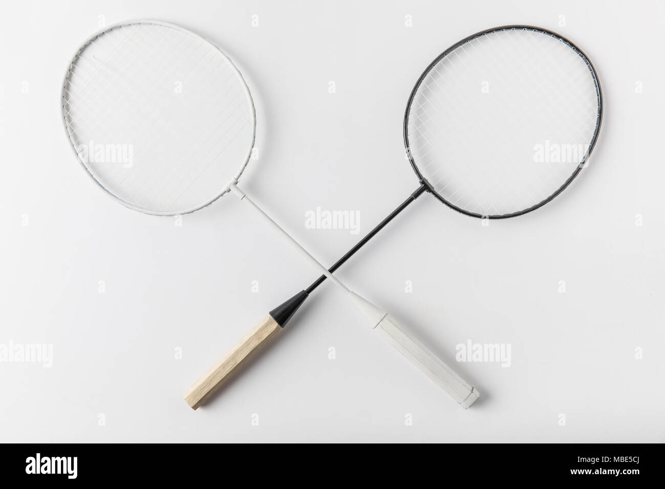 top view of crossed badminton rackets on white surface Stock Photo - Alamy