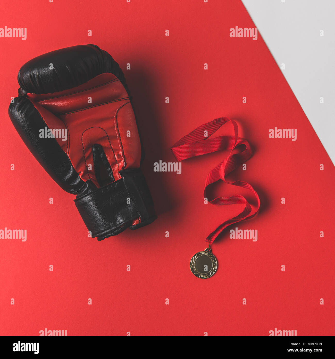 top view of boxing glove with medal on red surface Stock Photo - Alamy