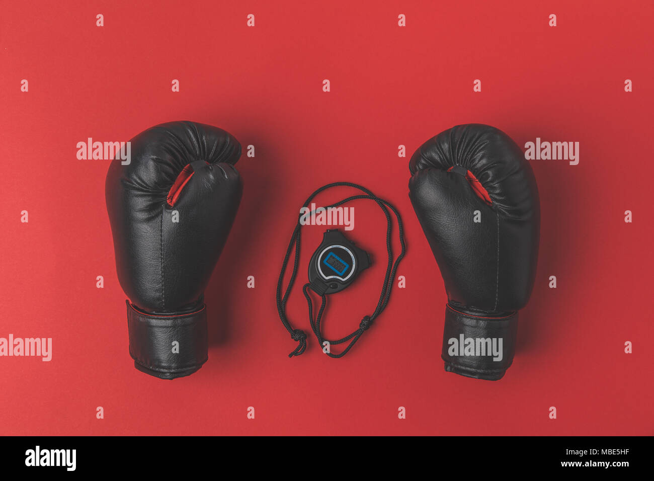 top view of boxing gloves with stopwatch on red tabletop Stock Photo ...