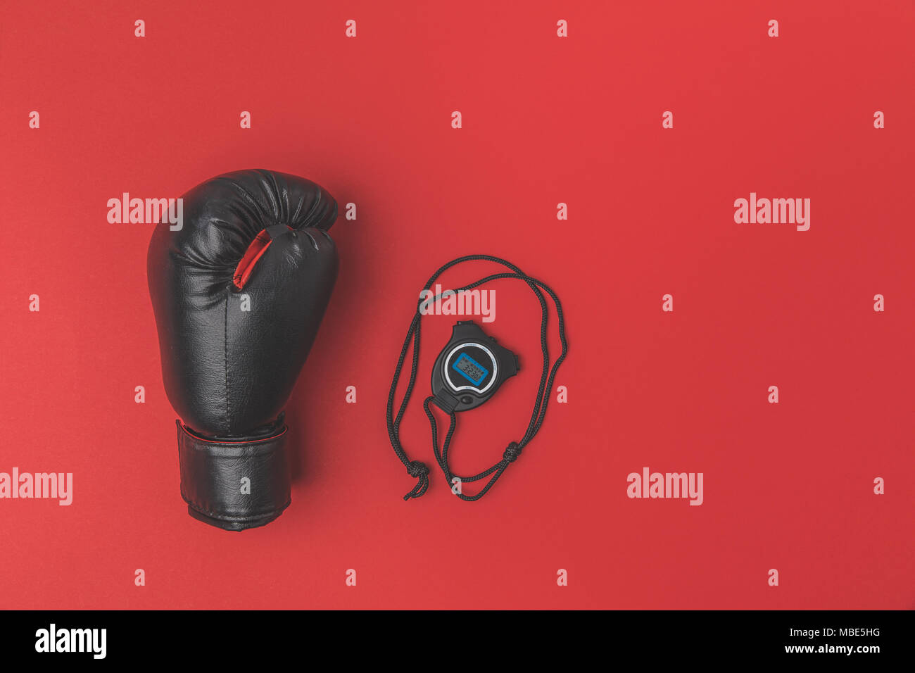 top view of boxing glove with stopwatch on red tabletop Stock Photo - Alamy