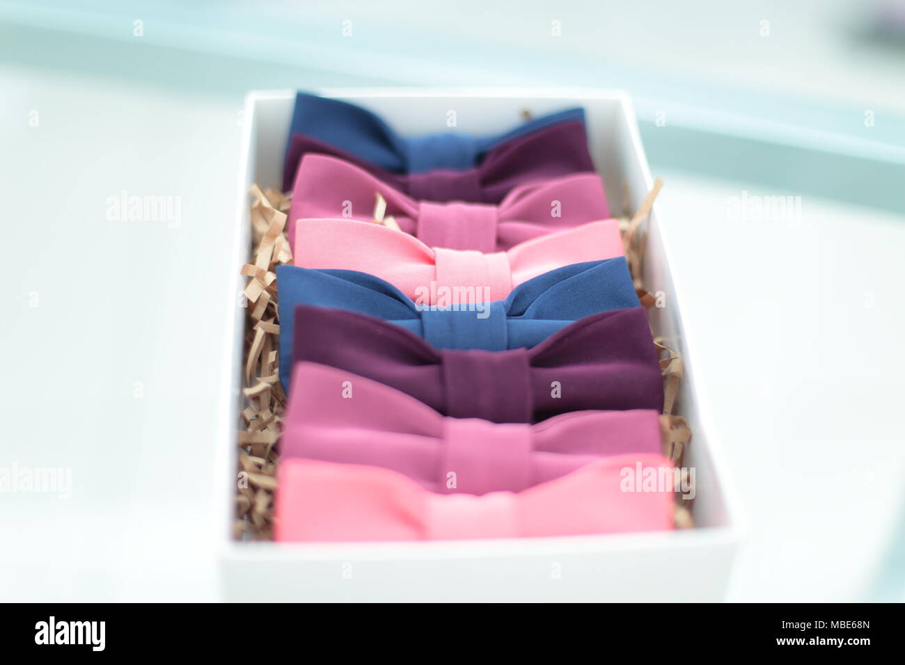Different bow ties on glass table background Stock Photo - Alamy