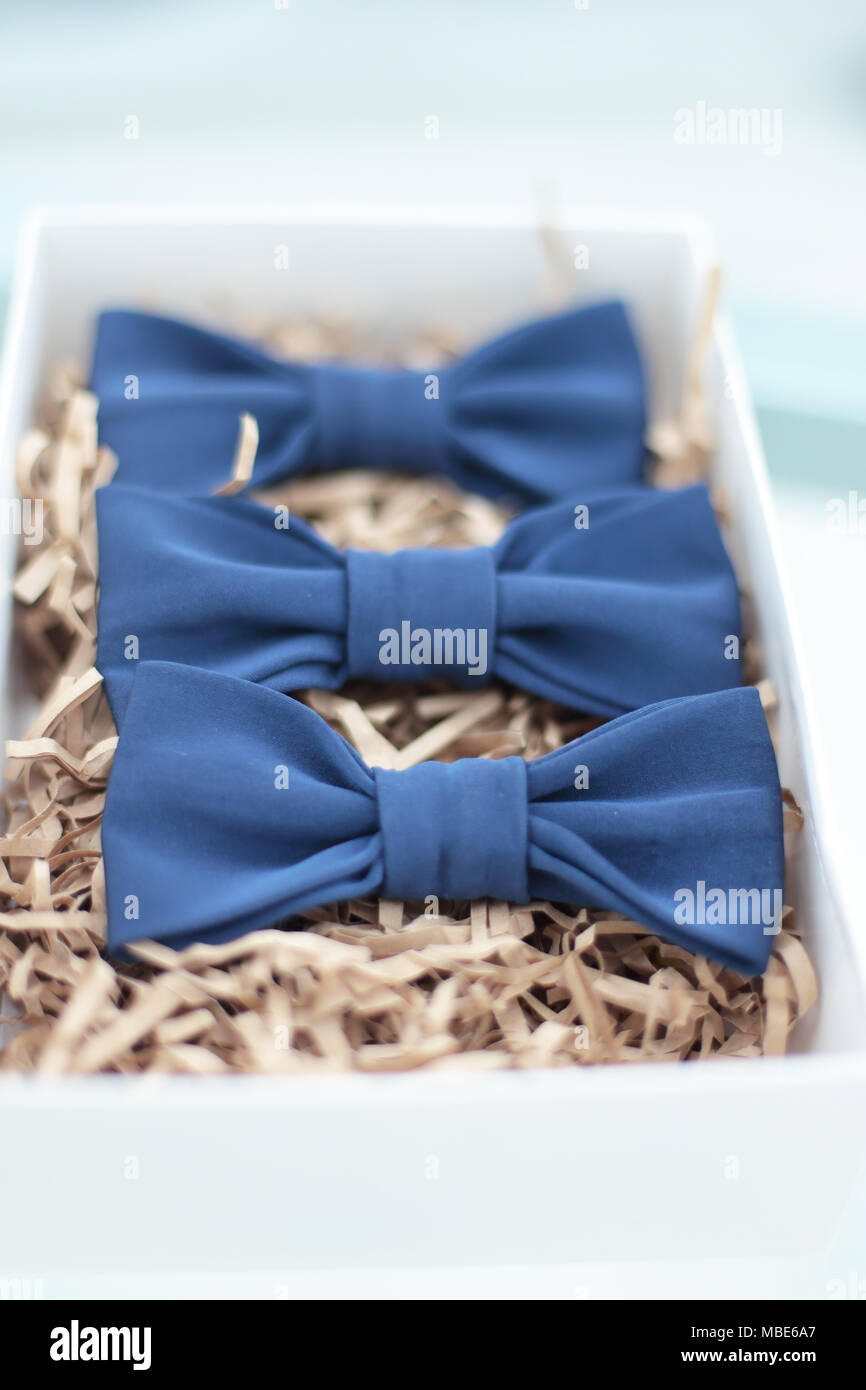 Different bow ties on glass table background Stock Photo - Alamy
