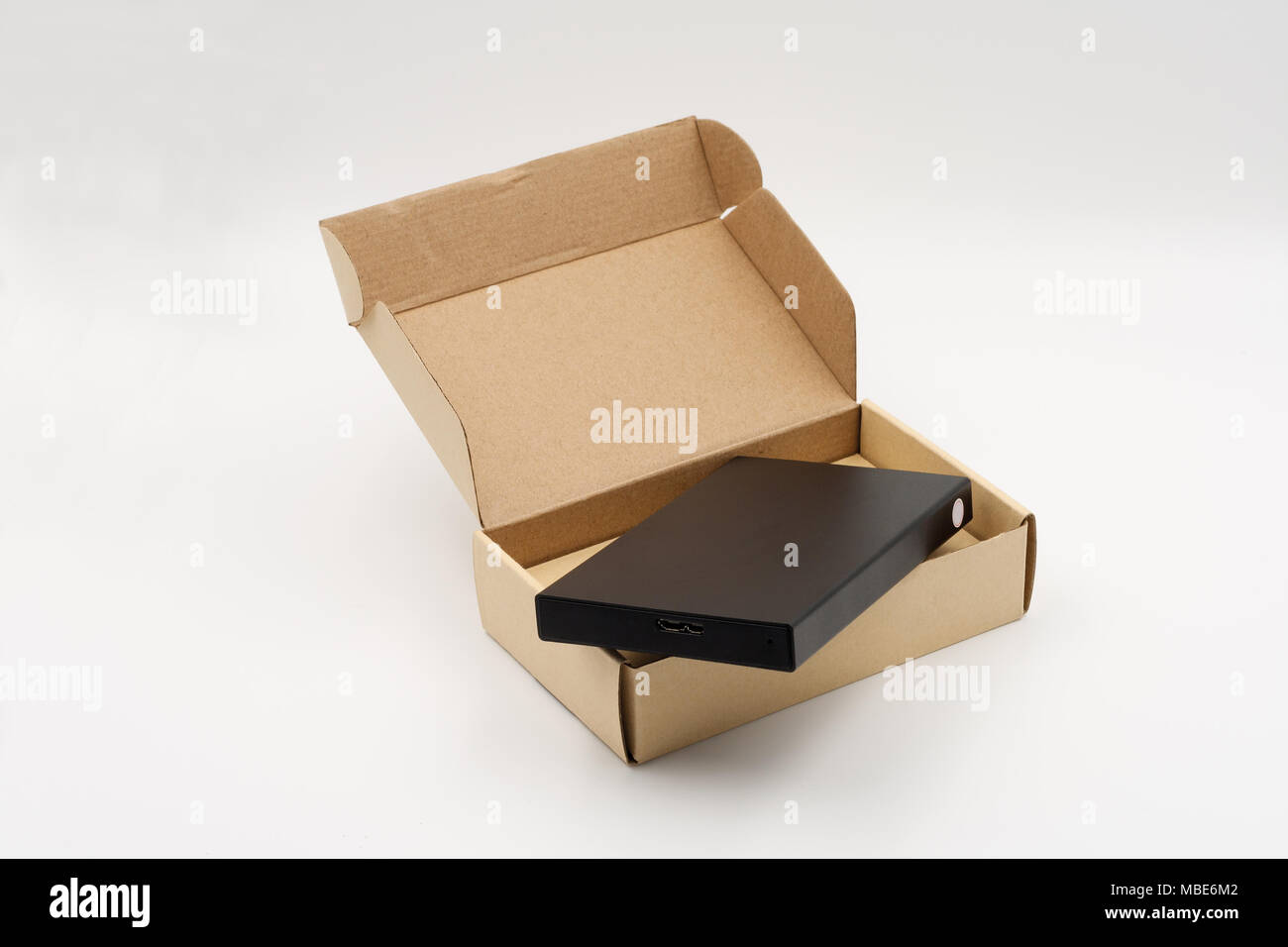 External hard drive of the computer in a cardboard box. Isolated on ...
