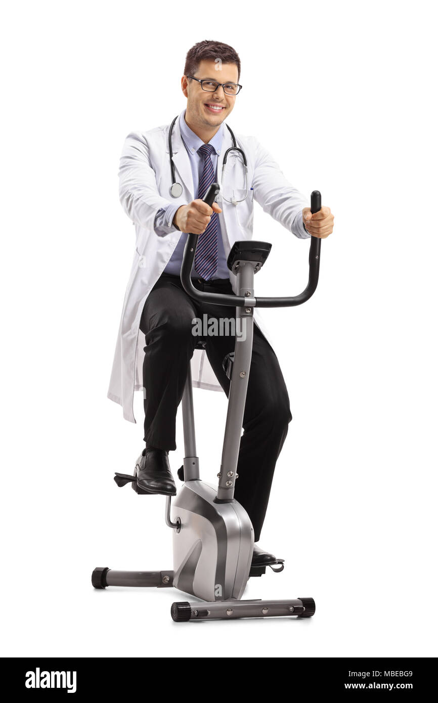 Doctor exercising on a stationary bike isolated on white background ...