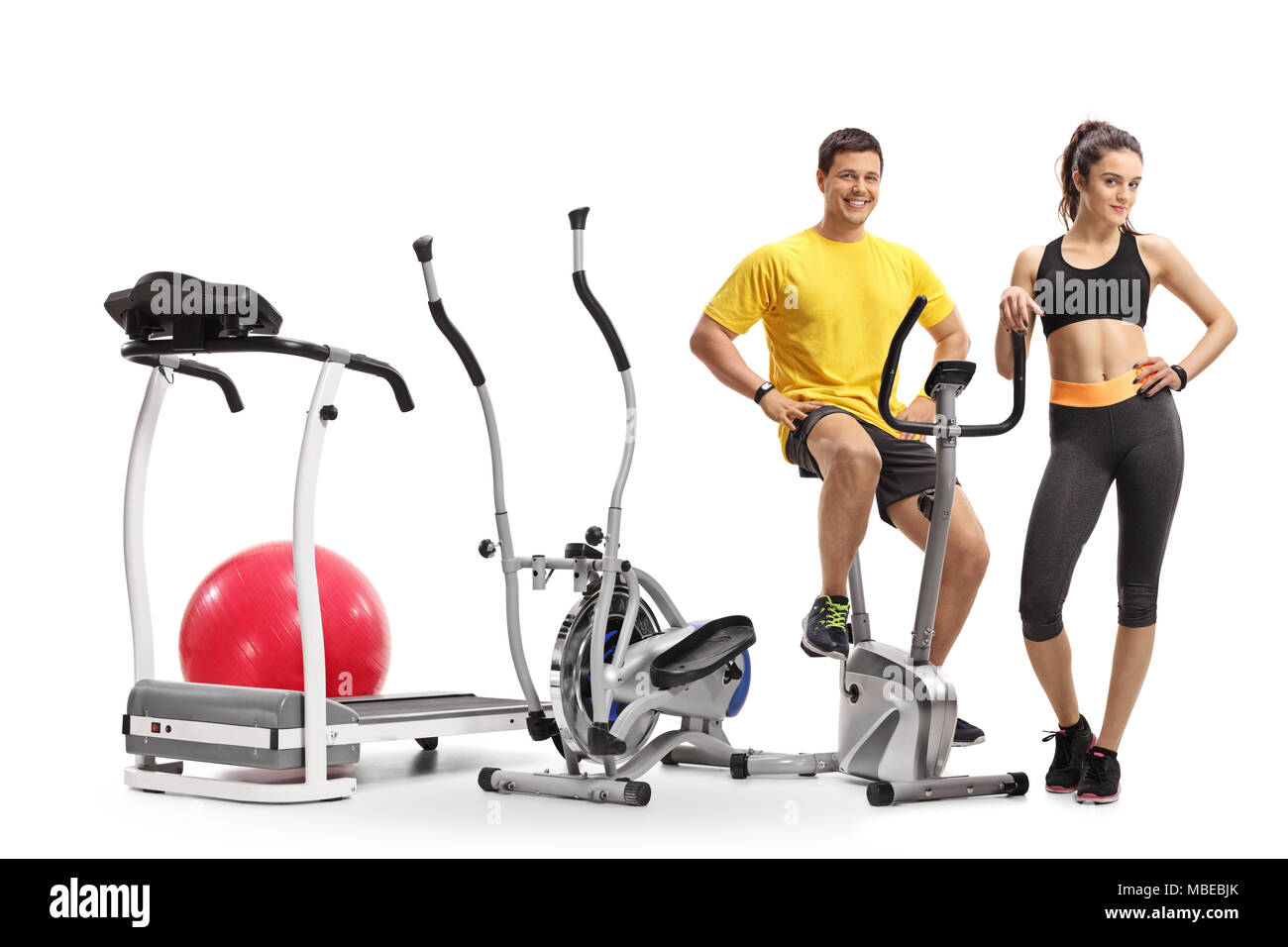 Young man and a young woman with exercising machines isolated on white ...