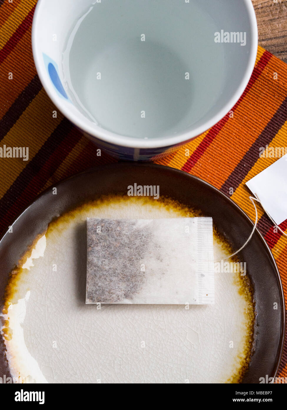 Teabag in a plate with a cup of water Stock Photo - Alamy
