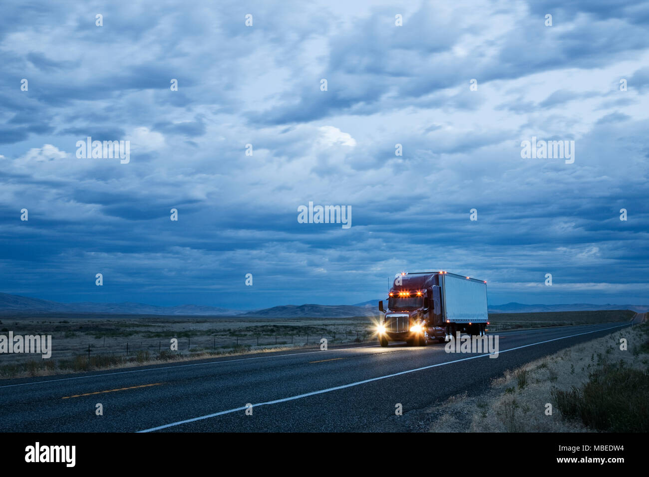 3/4 front view of a commercial truck on the road in the early evening ...