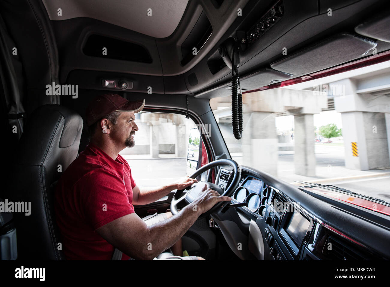 Interior cab view of a Caucasian man driving his commercial truck Stock ...