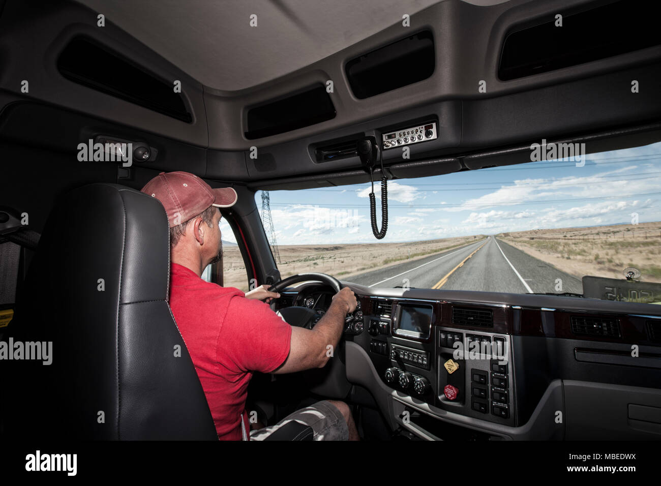 Interior cab view of a Caucasian man driving his commercial truck Stock ...