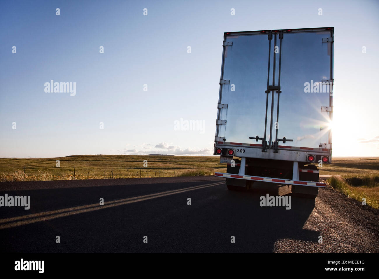 Rear view of the trailer on a Class 8 commercial truck on the highway ...