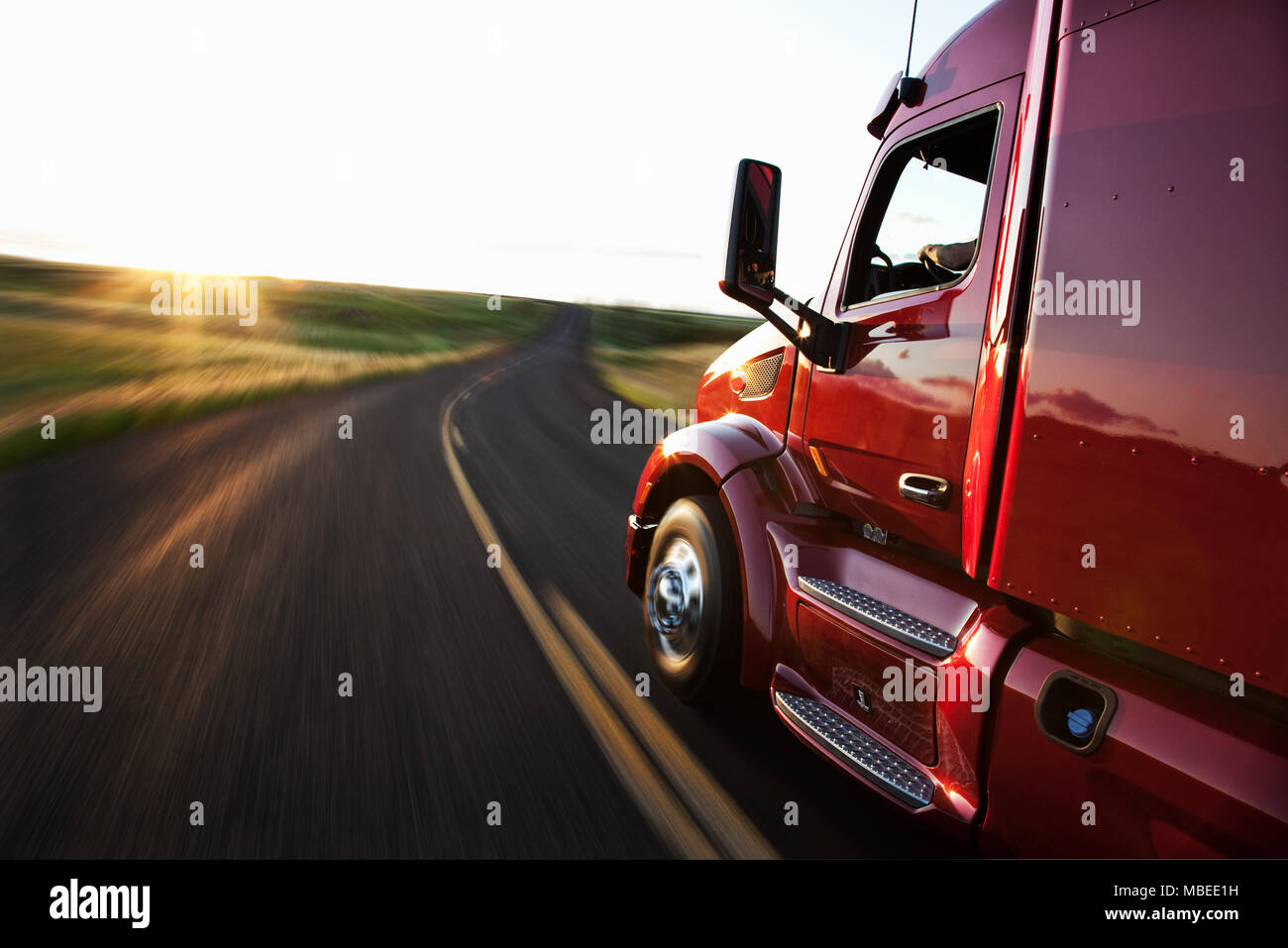 Close up side view looking forward of a commercial truck on a highway ...