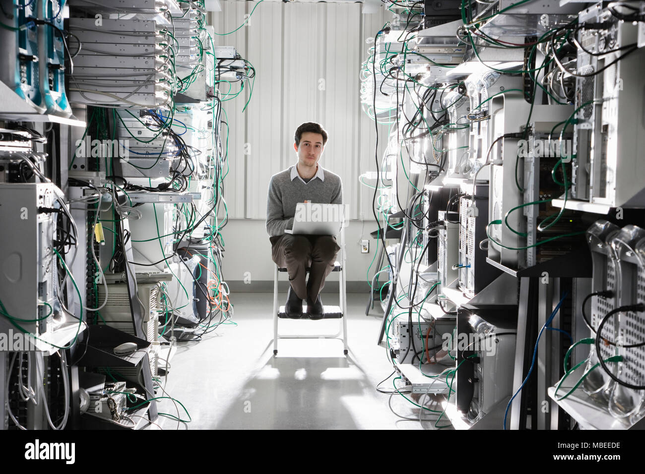 Caucasian male technician working on computer servers in a computer ...