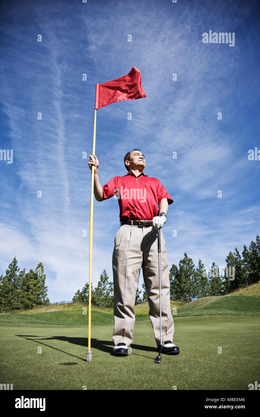 A senior golfer ready to approach the next shot on a golf course Stock ...