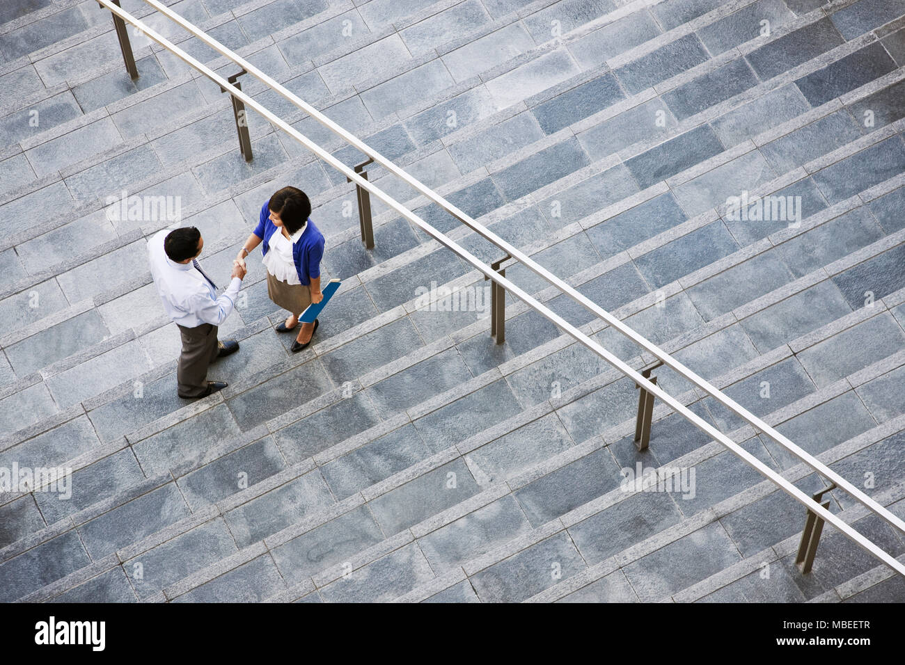 View from above looking down on a businesswoman and businessman ...