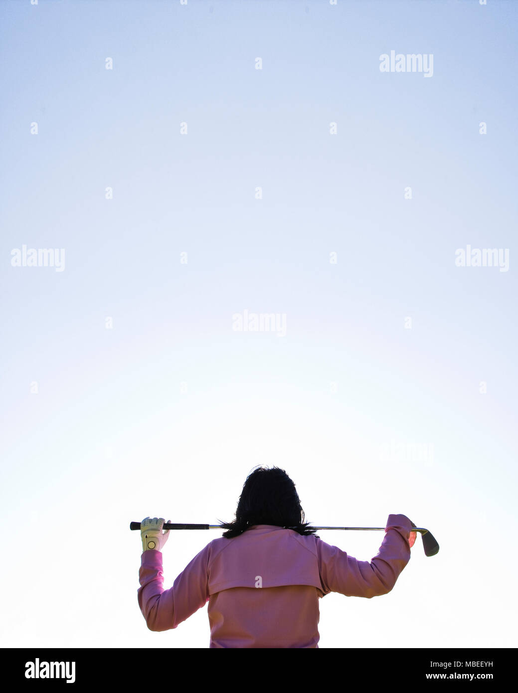 A woman golfer holding a club over her shoulders Stock Photo - Alamy