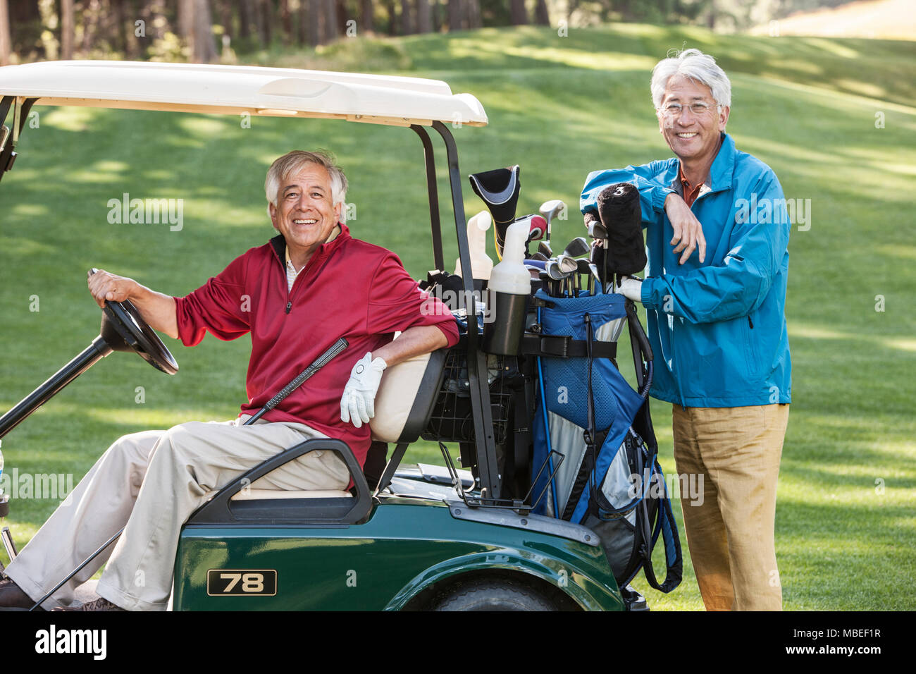 Two senior male golfing buddies and their golf cart and clubs Stock Photo - Alamy