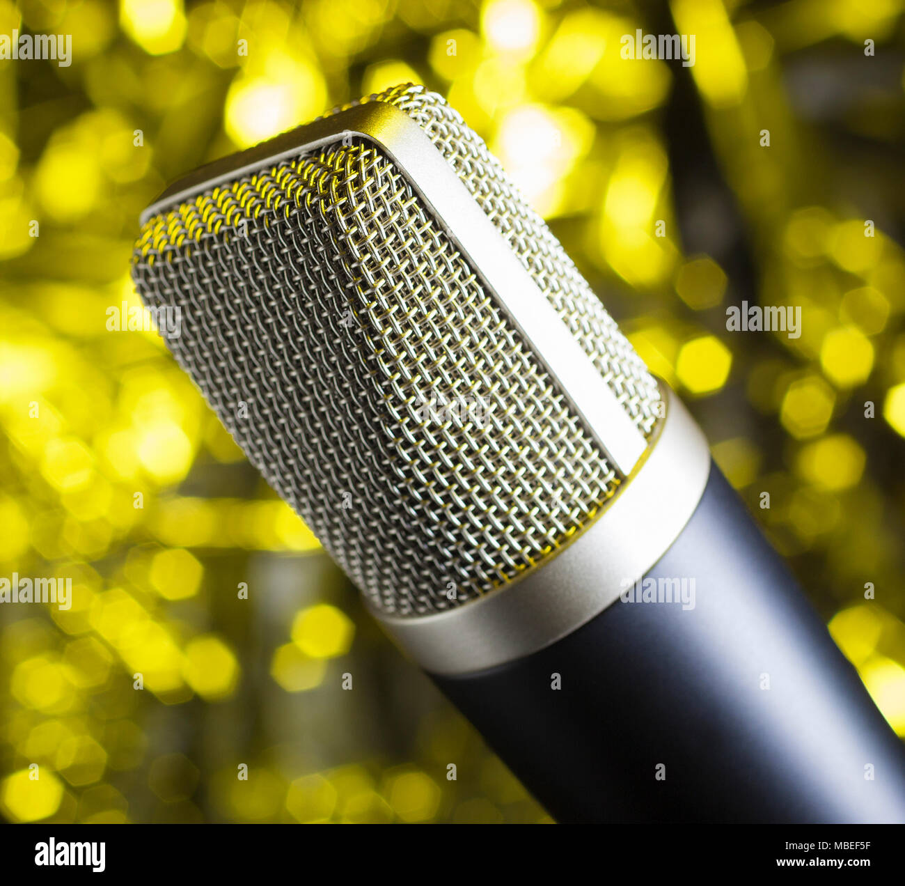Microphone with silver mesh on a bright yellow background Stock Photo ...