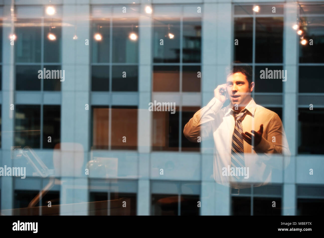 Reflection of businessman in office windows hi-res stock photography ...