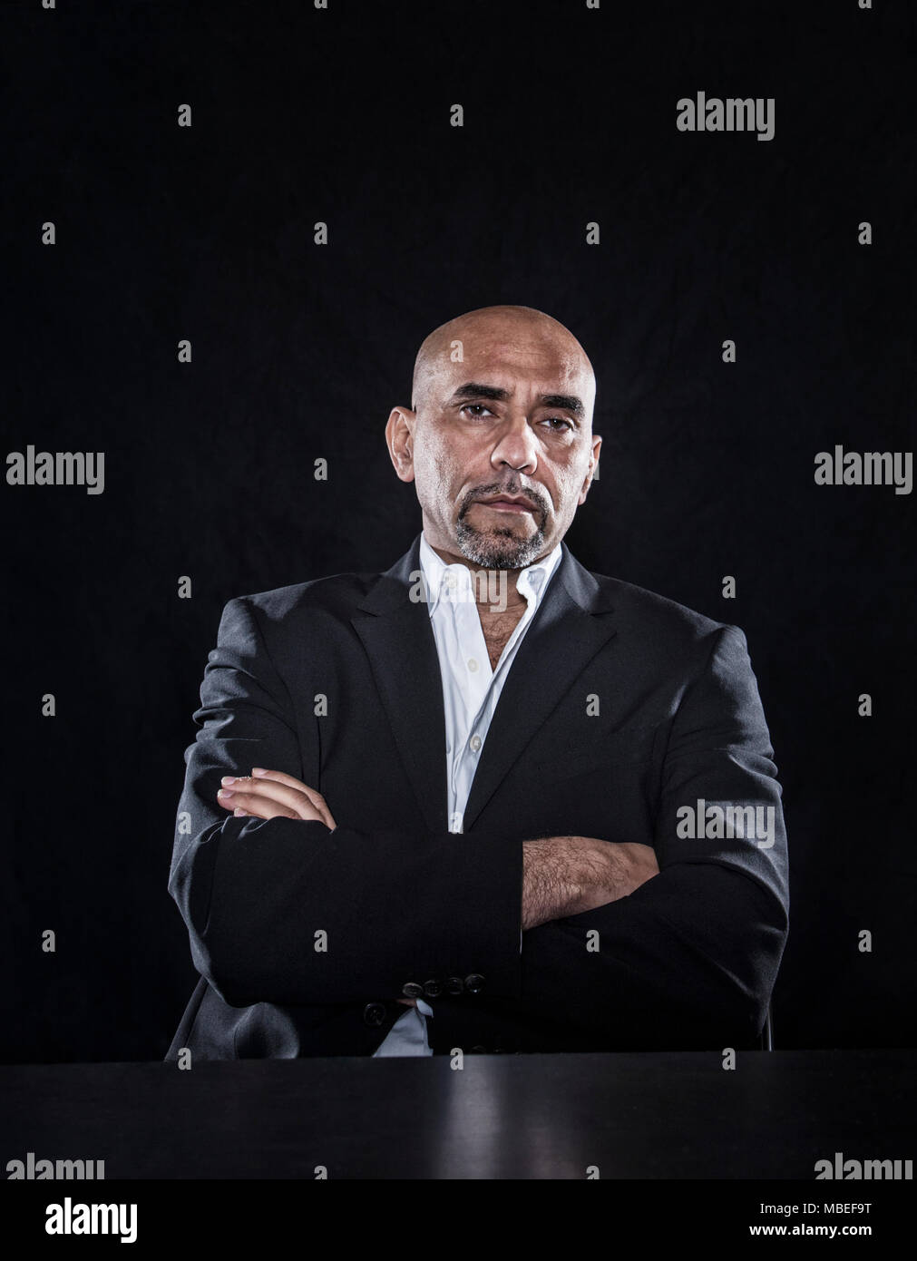 Studio portraits of hispanic man holding props Stock Photo - Alamy