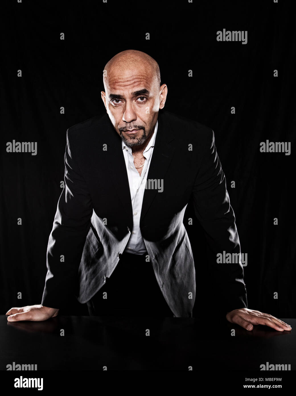 Studio portraits of hispanic man holding props Stock Photo - Alamy