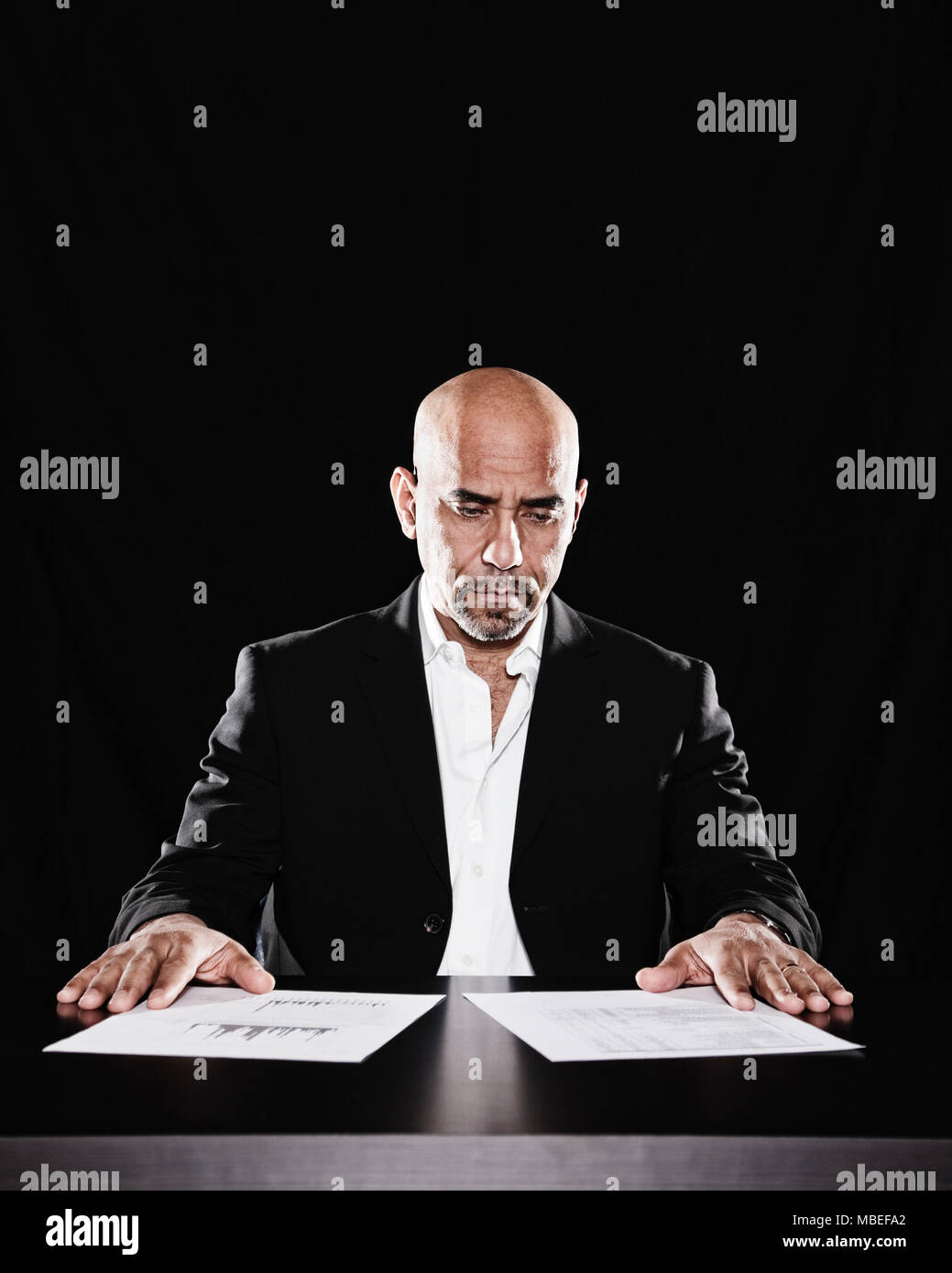 Studio portraits of hispanic man holding props Stock Photo - Alamy