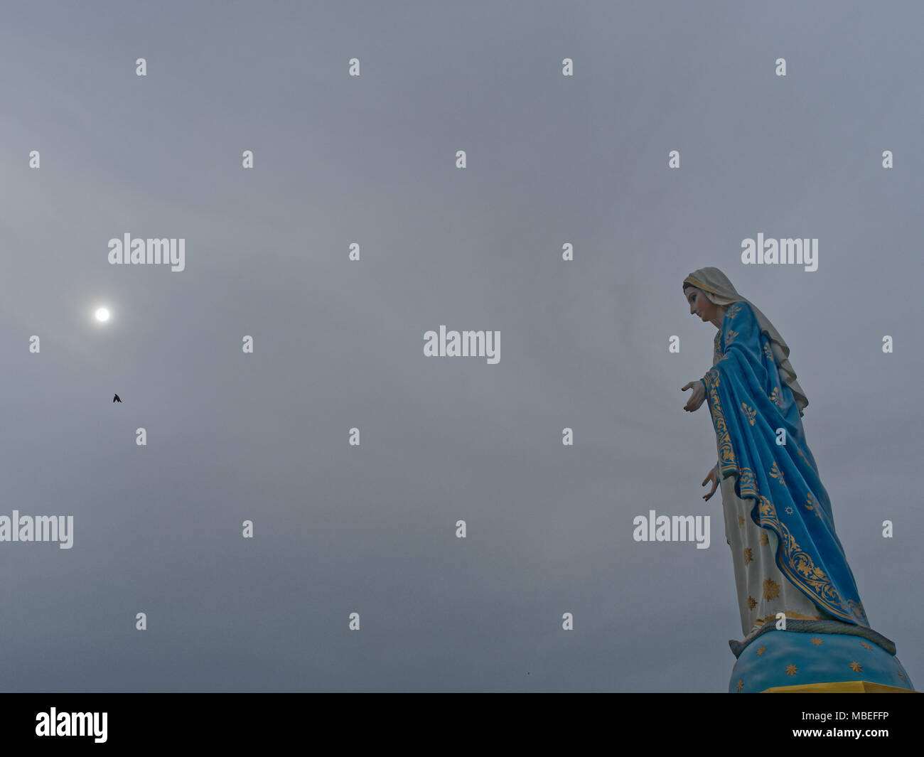 Blessed Virgin Mary, mother of Jesus, statue over dark sky background ...