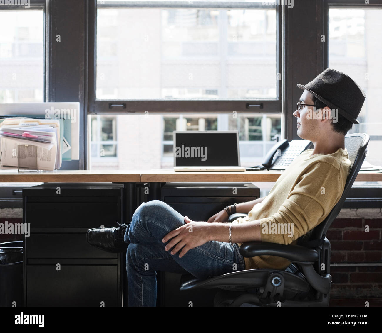 Hispanic male at his office workstation in a creative office Stock ...