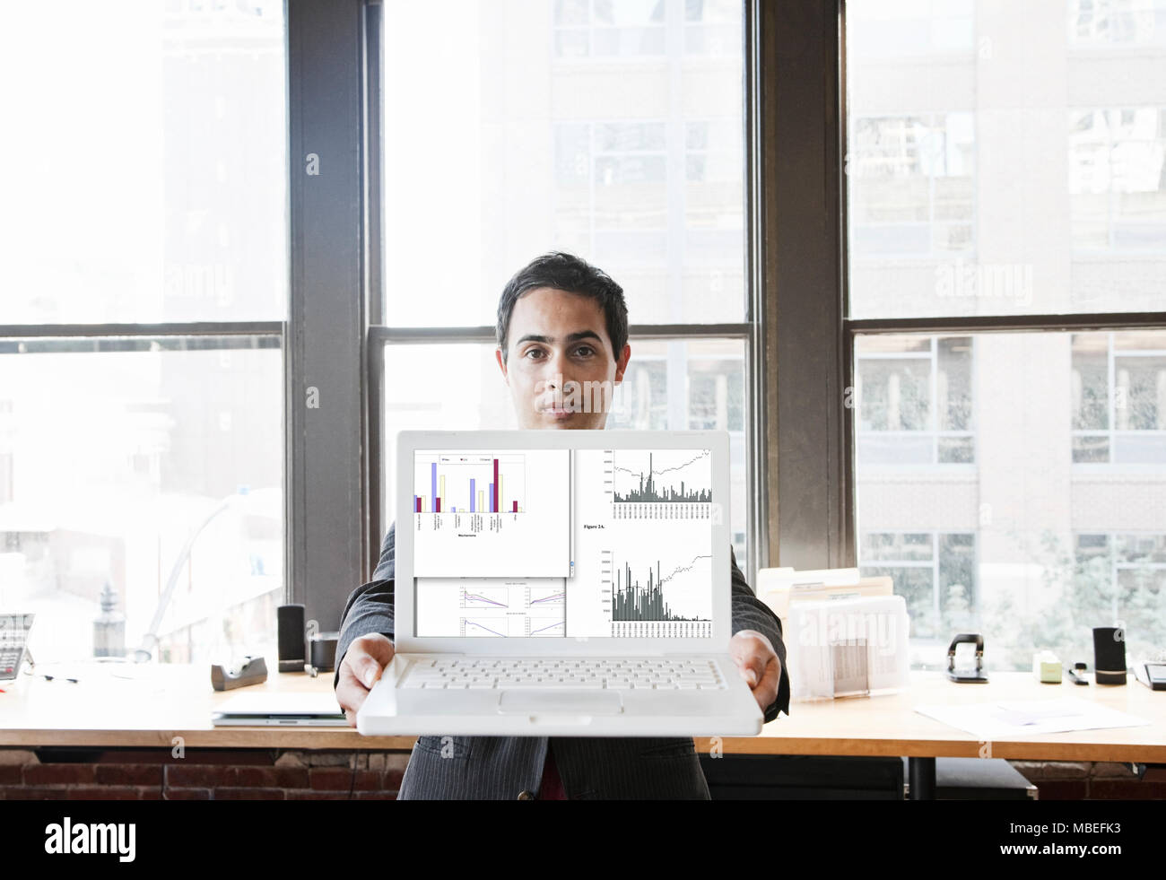 Hispanic man with his laptop at his office workstation Stock Photo - Alamy