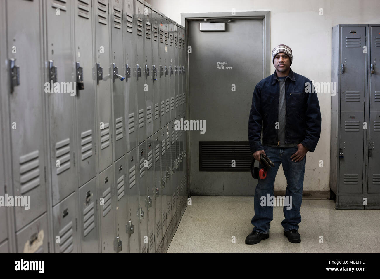 Black man factory worker standing next to lockers in a factory break ...